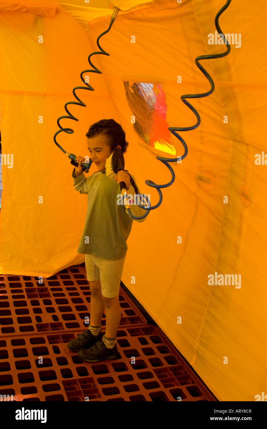 Small boy tries out a chemical decontamination unit and shower Stock ...