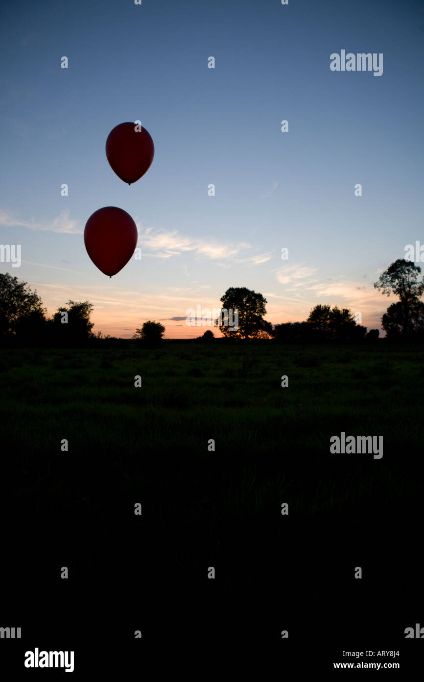 Two balloons floating off into the air Stock Photo - Alamy
