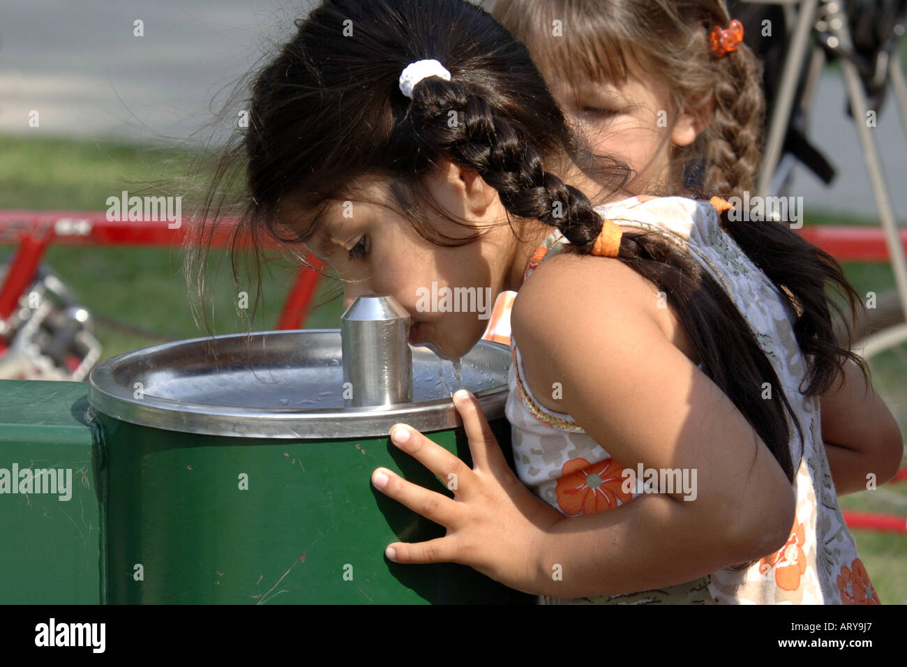 Pre-K female sips water from a drinking fountain Stock Photo - Alamy