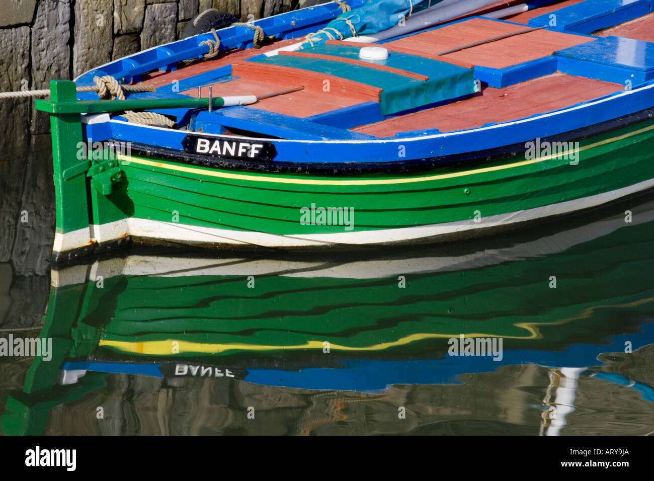 Ship. abstract reflections on Moored brightly coloured boat at Portsoy ...