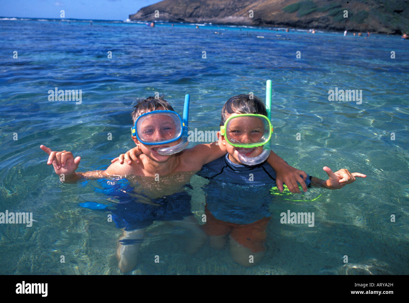 Two young boys (age 8) enjoy spending the day exploring the coral reefs ...
