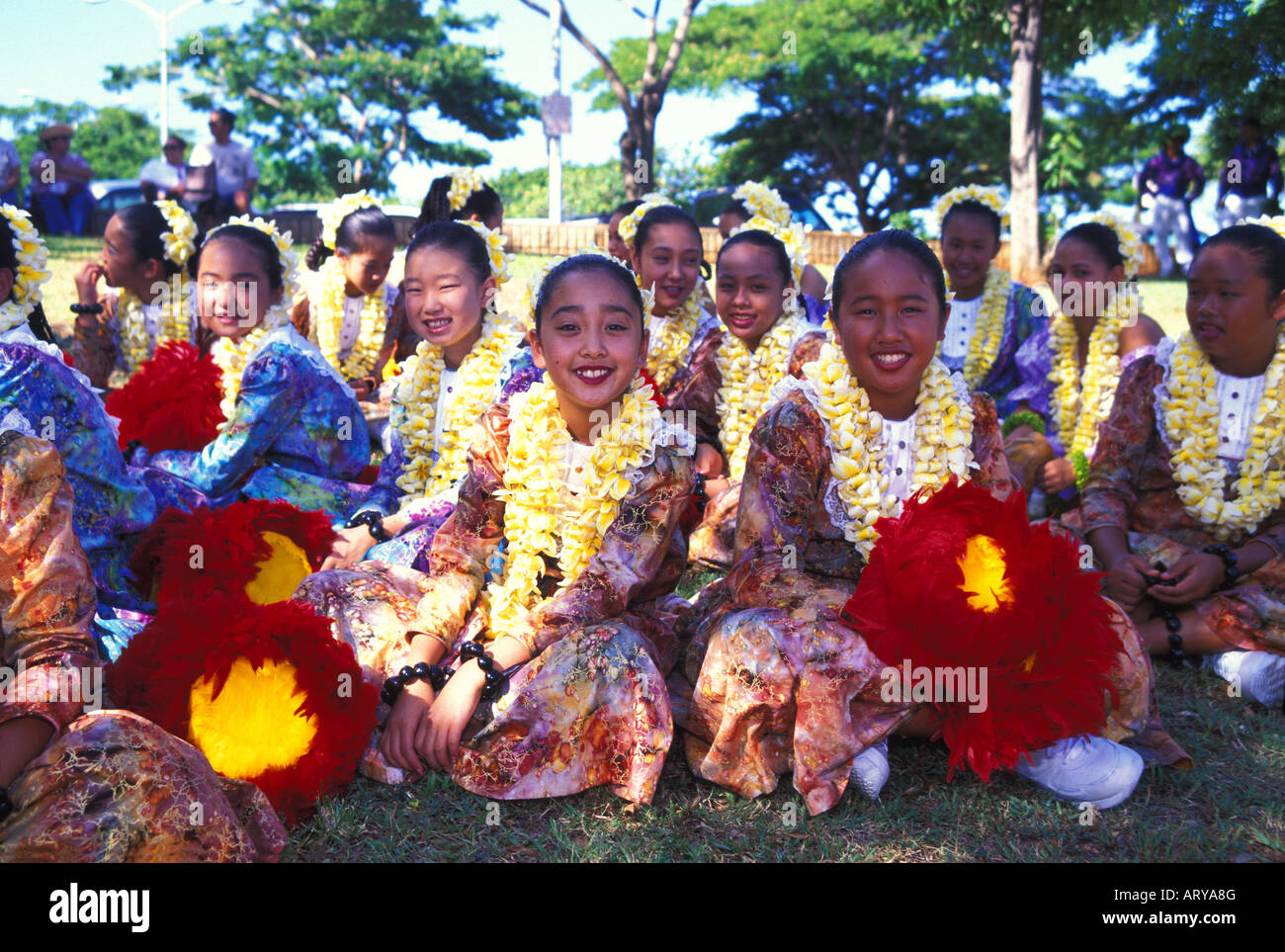 People in costumes with leis and feather rattles uli uli at the annual ...