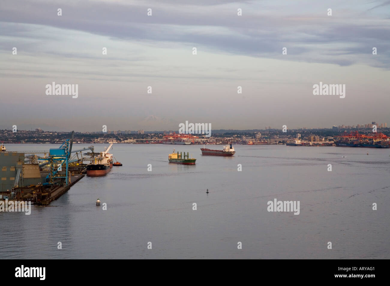 Docks and industrial area of city with Mount Baker behind pollution ...