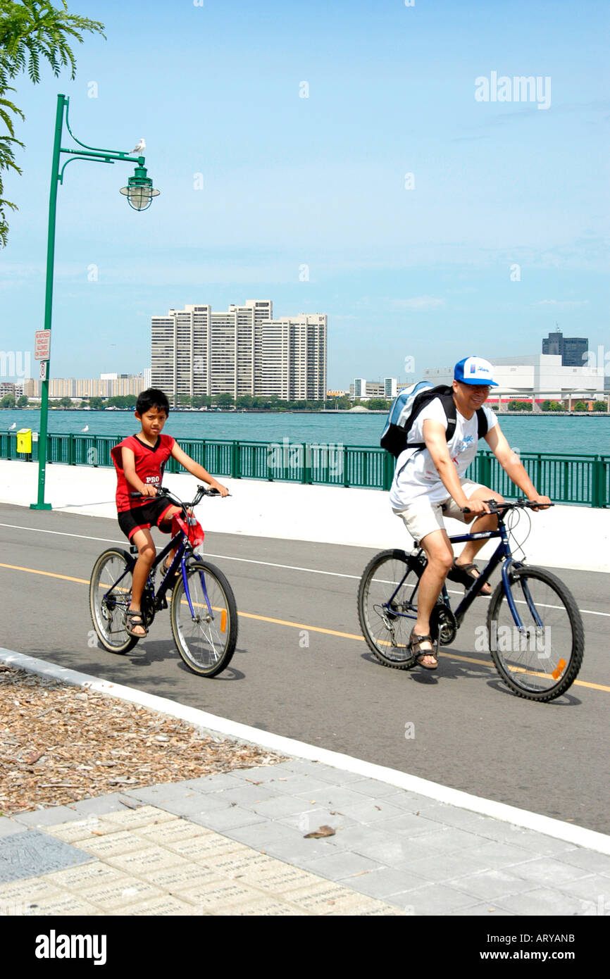 Ethnic chinese boy riding a bicycle with his father Stock Photo - Alamy