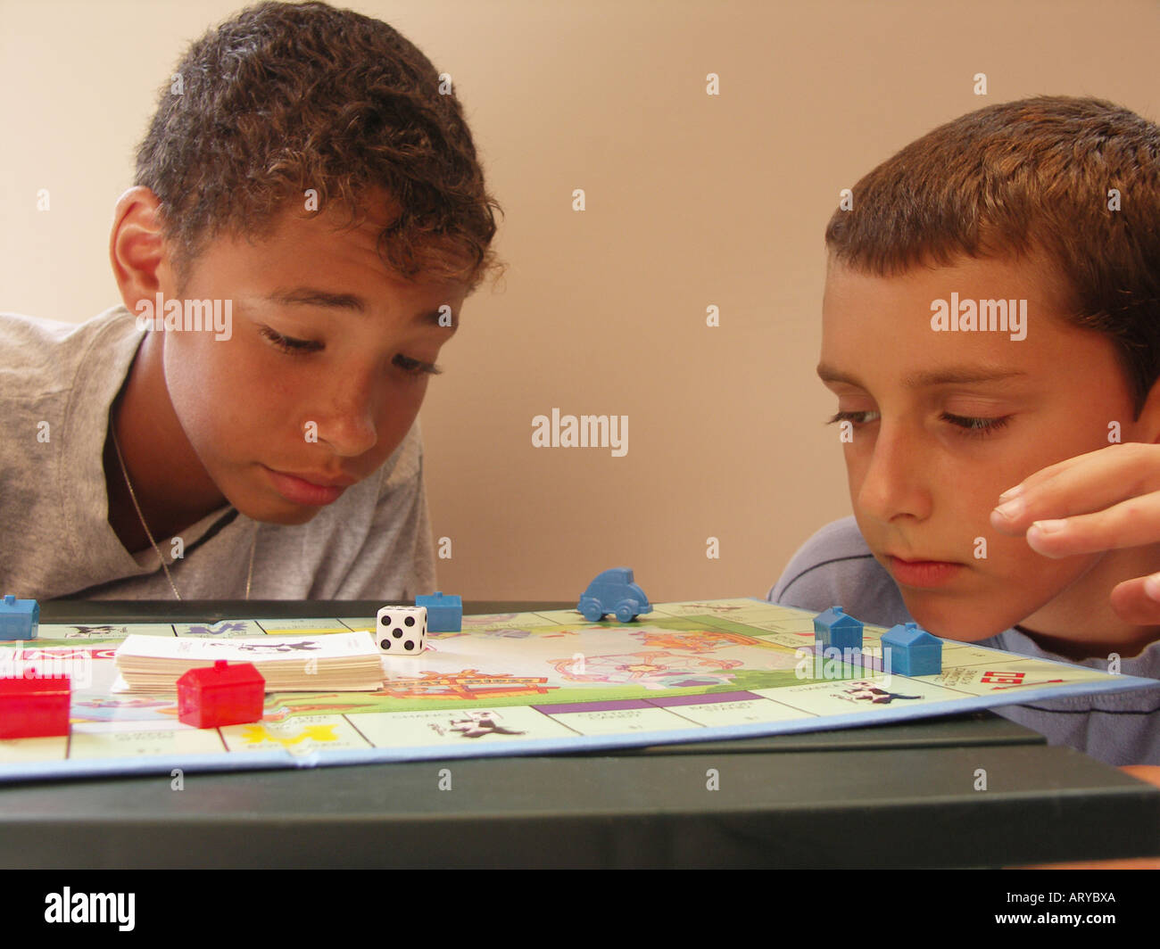 Young Boys Playing Board Game Stock Photo - Alamy