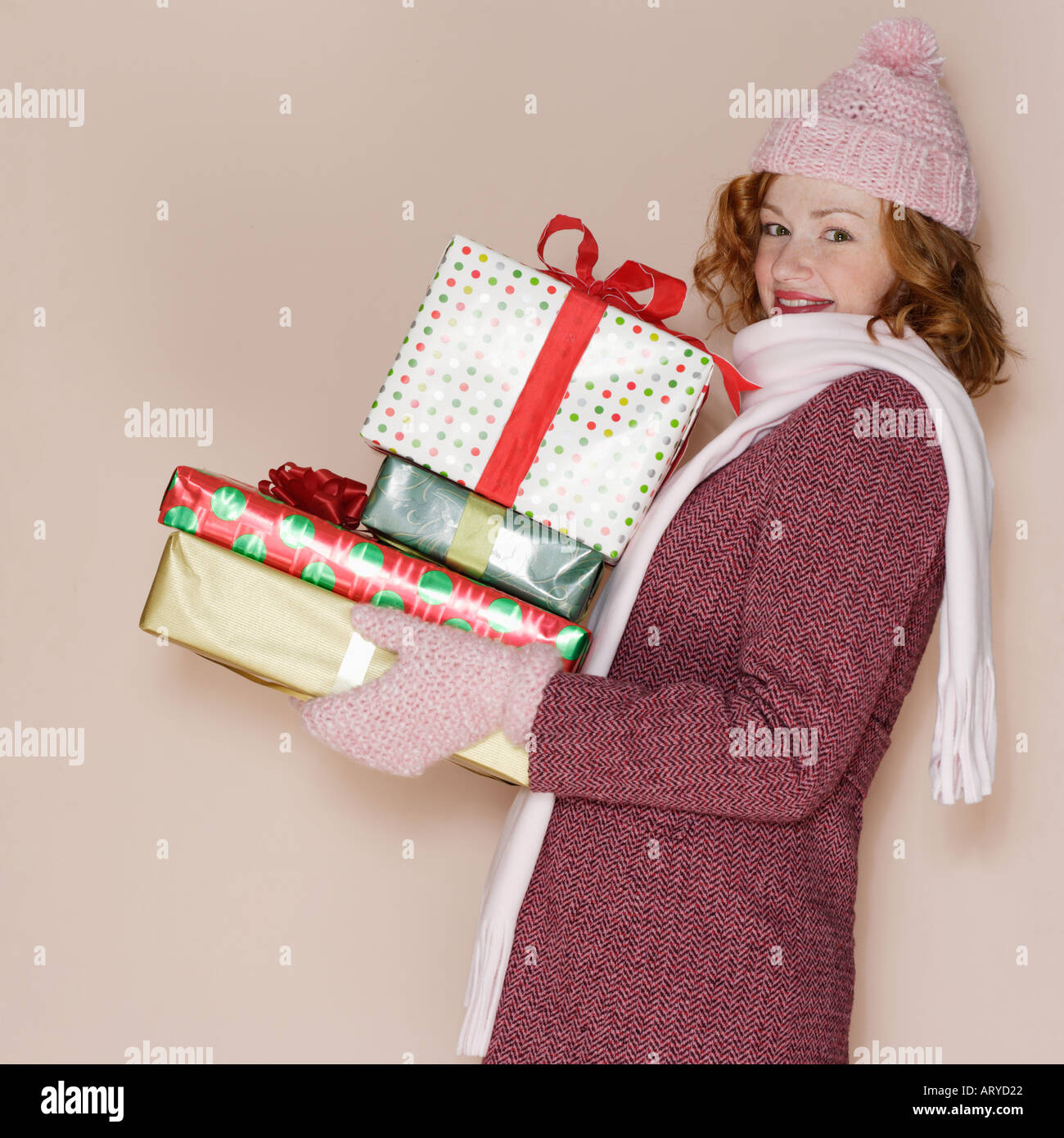 Woman carrying pile of presents Stock Photo - Alamy