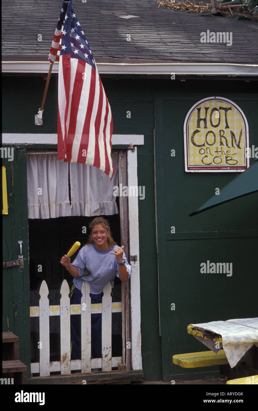 Young woman selling sweet corn Stock Photo - Alamy