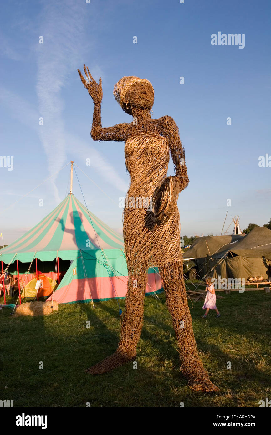 Giant wicker sculpture waves farewell to the evening sun as young girl ...