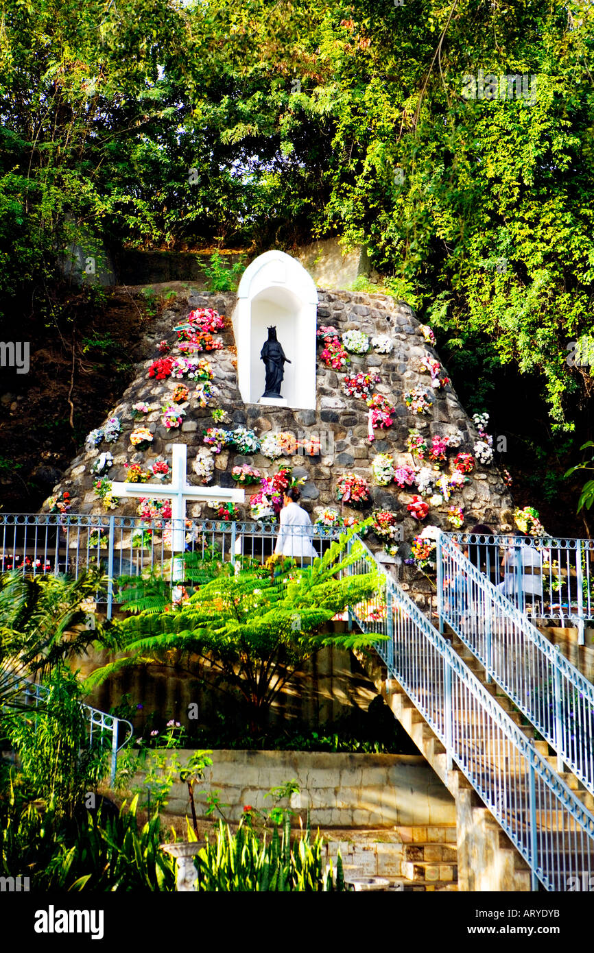 Flower offerings and prayers at the Grotto of La Vierge Noire in ...
