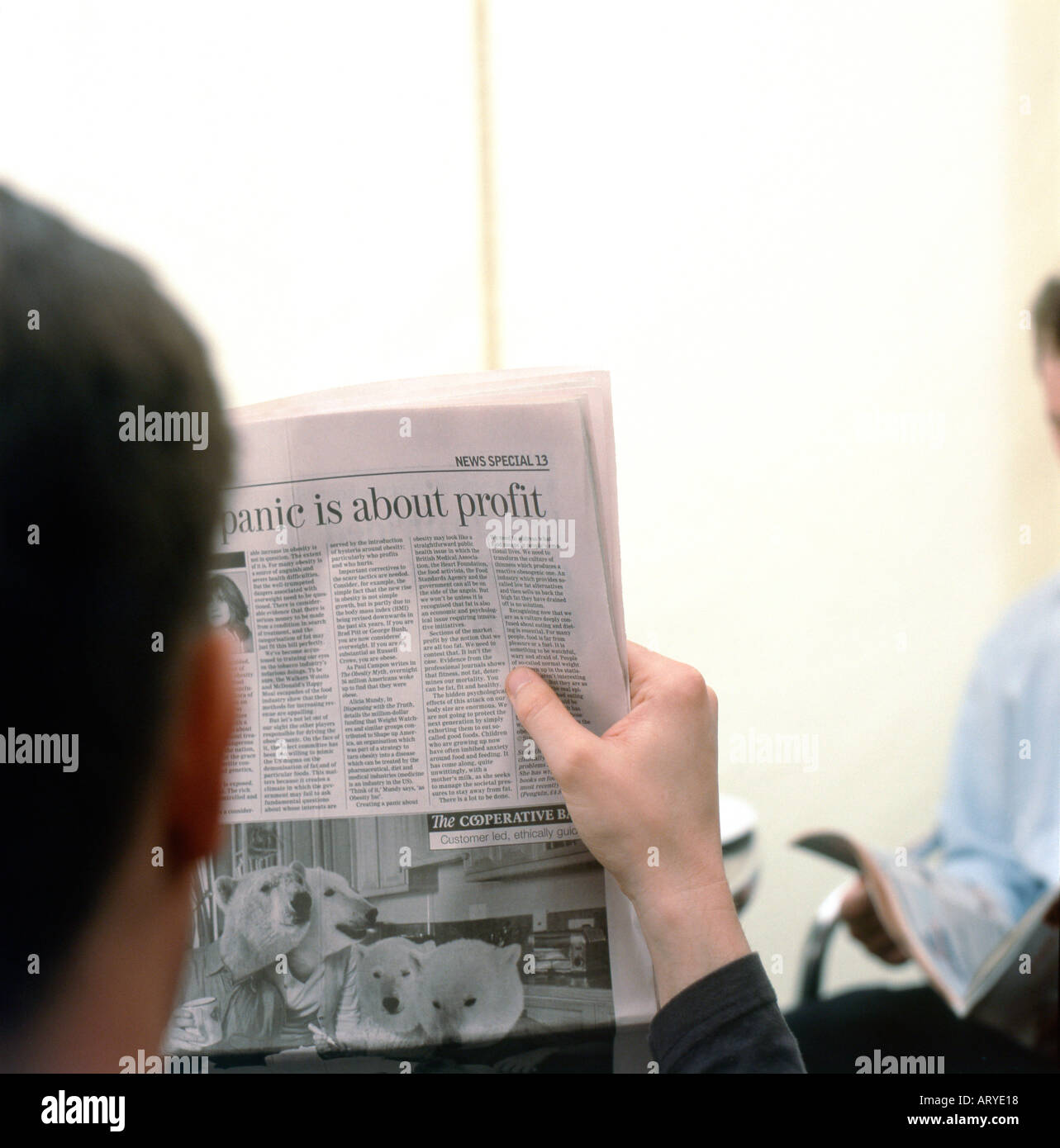 Rear view of a man reading the Guardian newspaper Stock Photo - Alamy