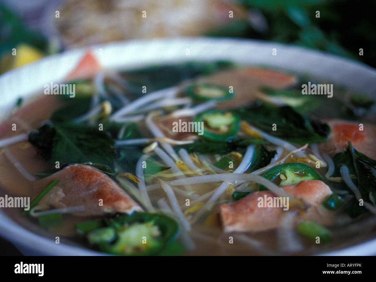 bowl of Pho, traditional Vietnamese noodle soup with sliced beef, chili ...
