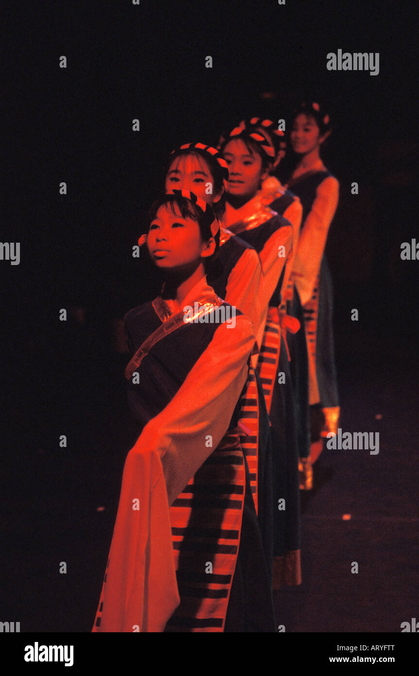 Chinese acrobatic act, girls in traditional dress standing in a line ...