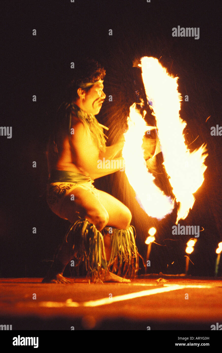 Man performing a Polynesian fire dance, the entertainment at a luau ...