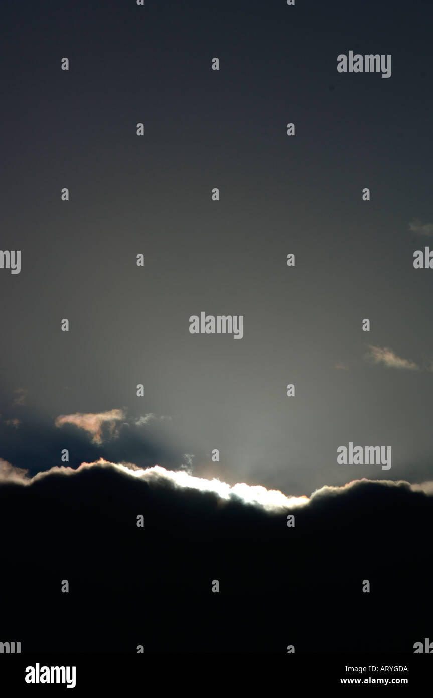 The Sun Rim Lighting A Cloud & Producing Sunbeams Stock Photo - Alamy