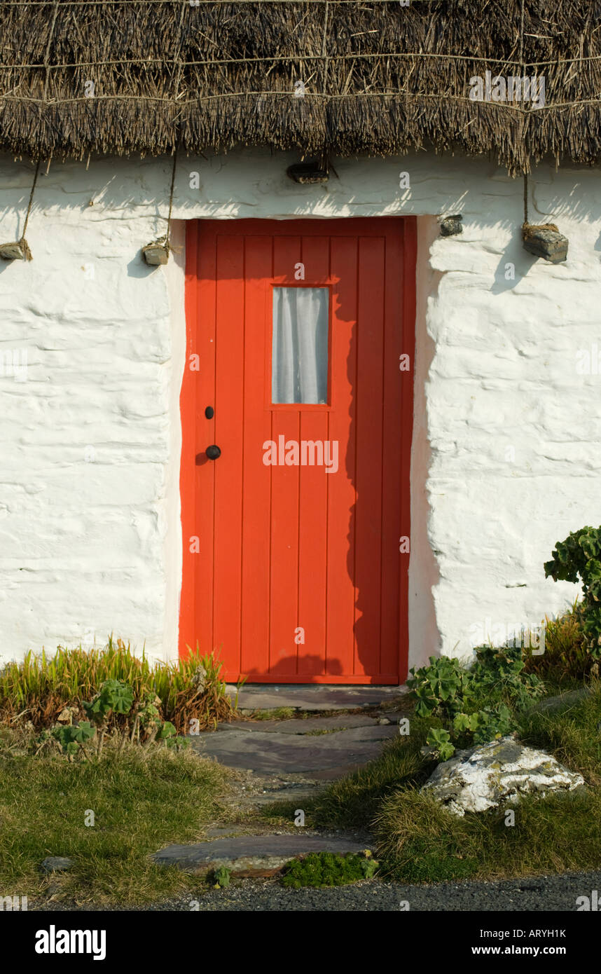 Red door on traditional manx cottage Stock Photo - Alamy