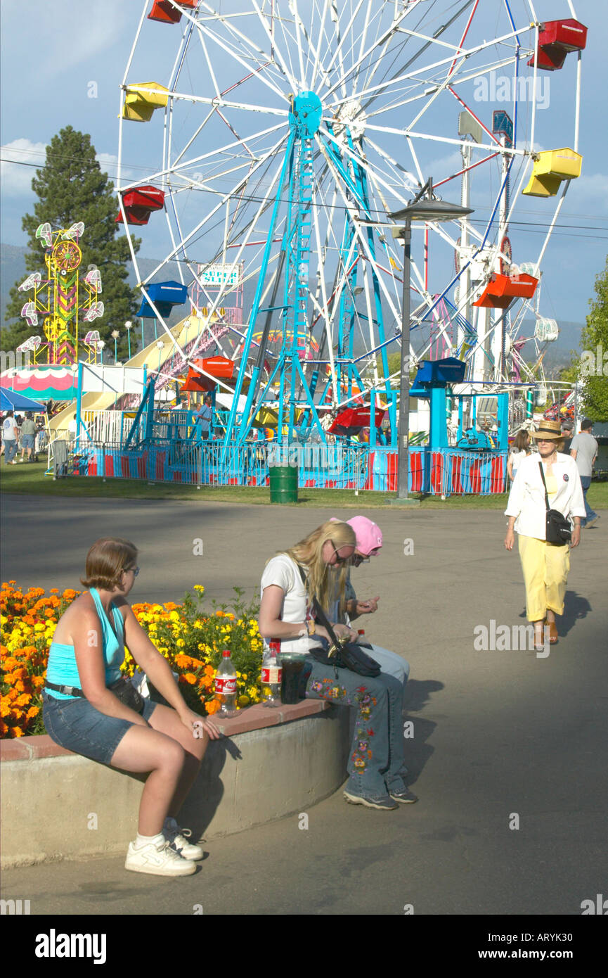 The ferris wheel and kids deciding what they want to do Stock Photo - Alamy