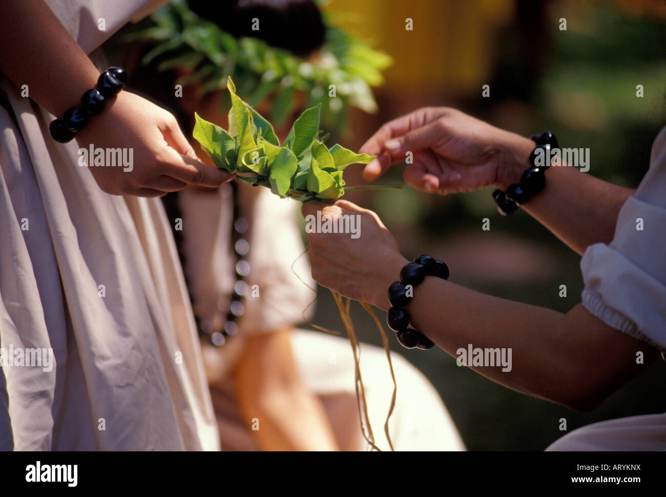Lei making as preparation for a hula performance at the Ka Hula Piko ...