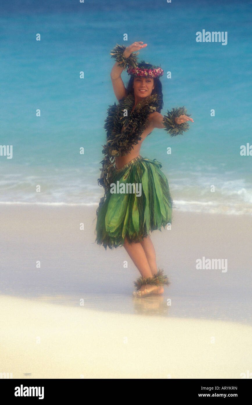 Woman dances hula at Kailua Beach in ti leaf skirt and leis. Oahu Stock ...
