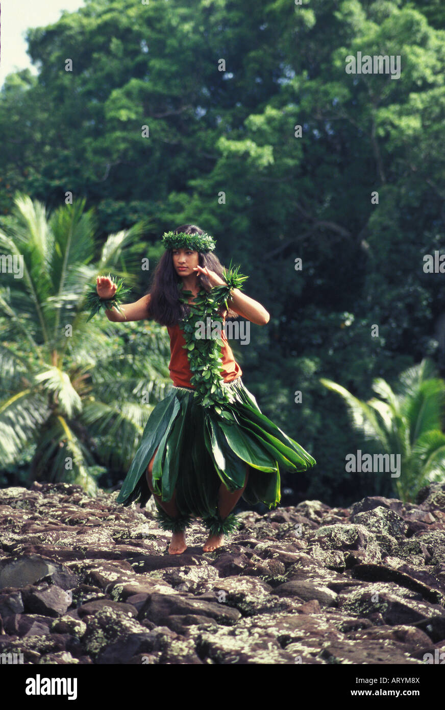 Young hula dancer in ti leaf skirt at Hawaiian heiau ( temple site ...