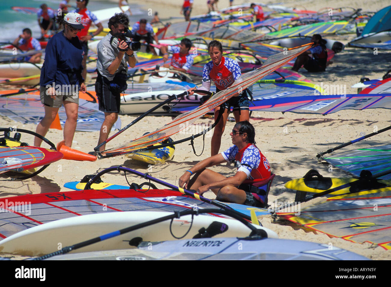 Cameraman filming windsurfer sitting down on beach at the 1998 United ...
