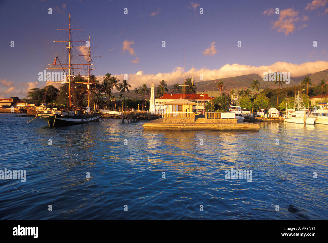 Lahaina Harbor at sunset. West Maui Mountains in the background, with ...