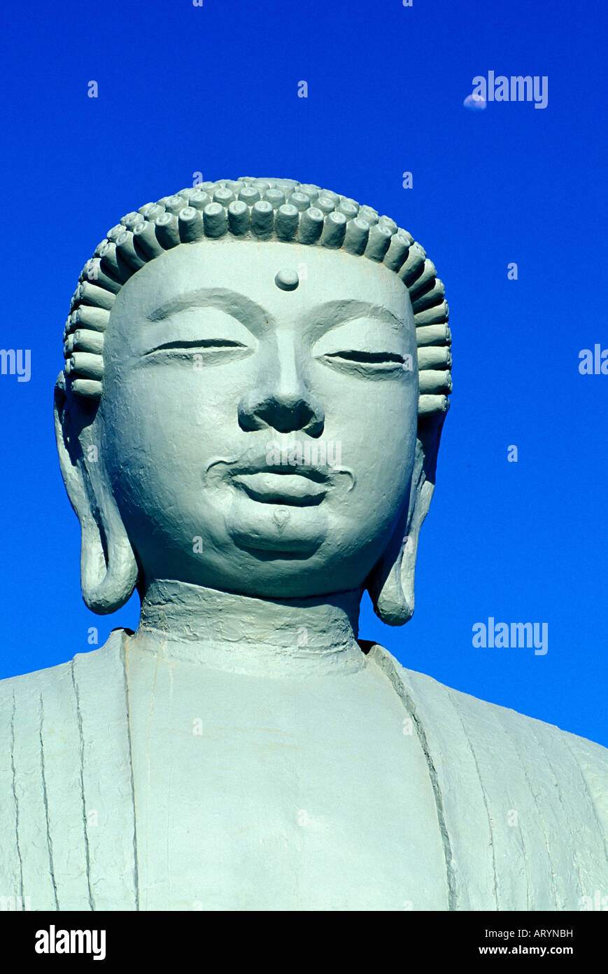 Buddha with moon overhead at the Lahaina Jodo Mission. This is one of ...