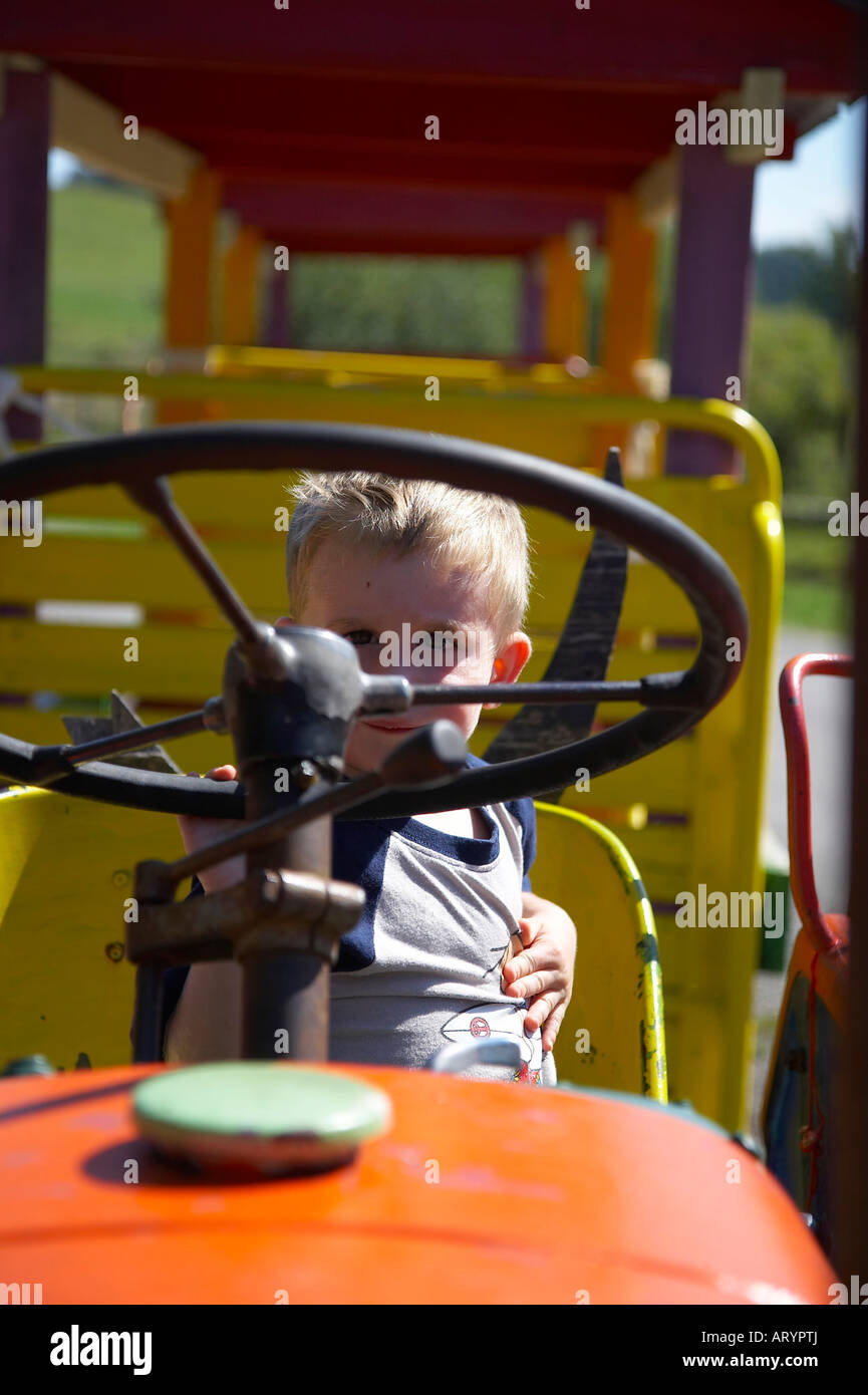 little boy sitting on tractor Stock Photo - Alamy