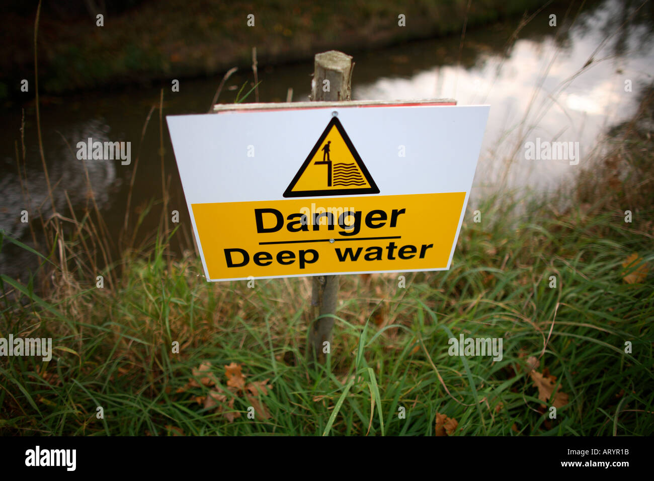 Danger deep water hazard signs near a river Stock Photo - Alamy