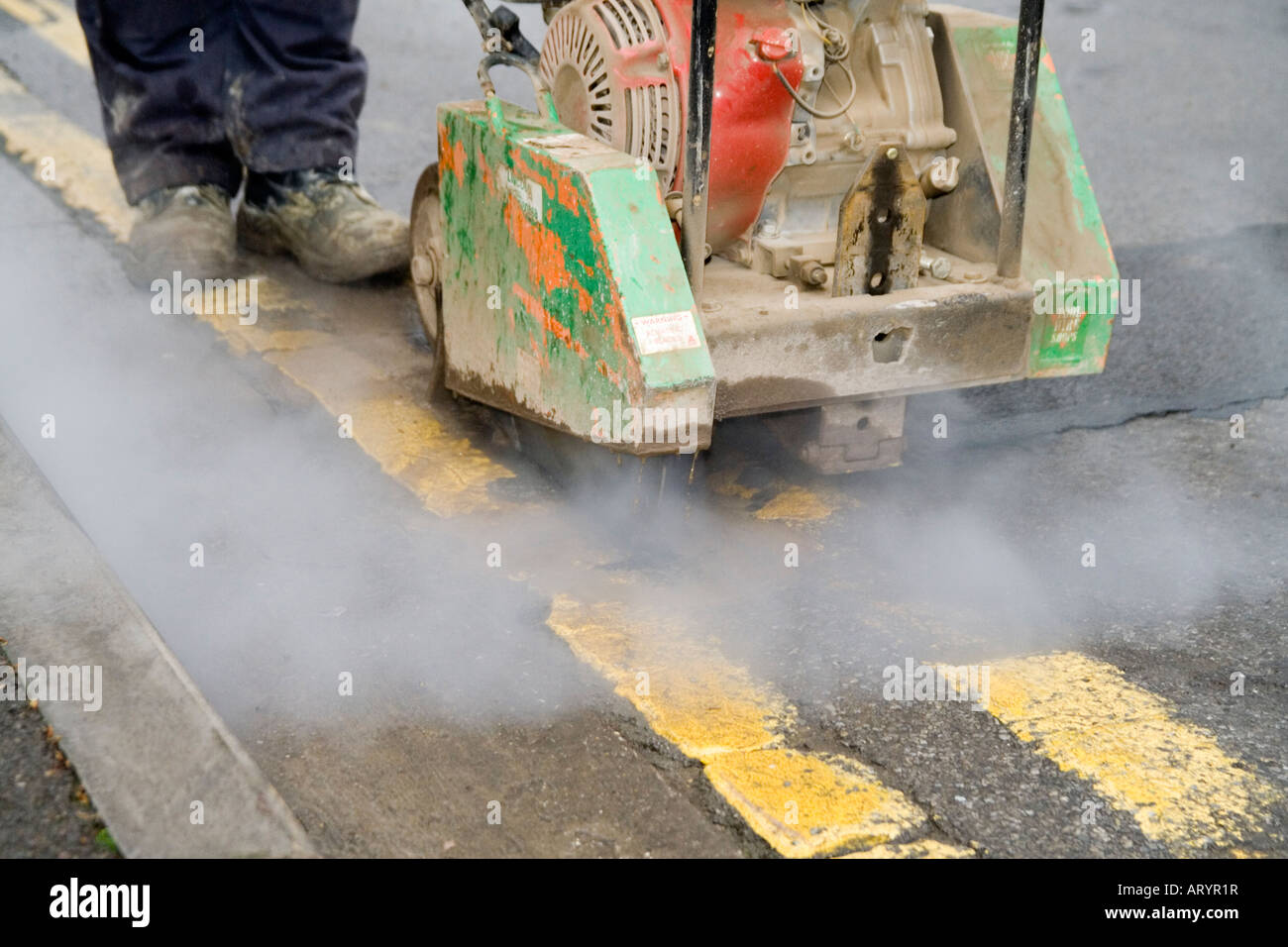 Road Saw, in action. Road engineering people.Health and Safety.painting ...