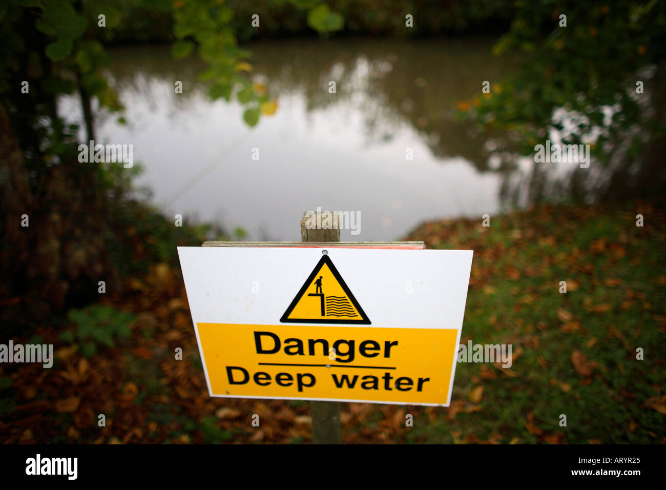 Danger deep water hazard signs near a river Stock Photo - Alamy