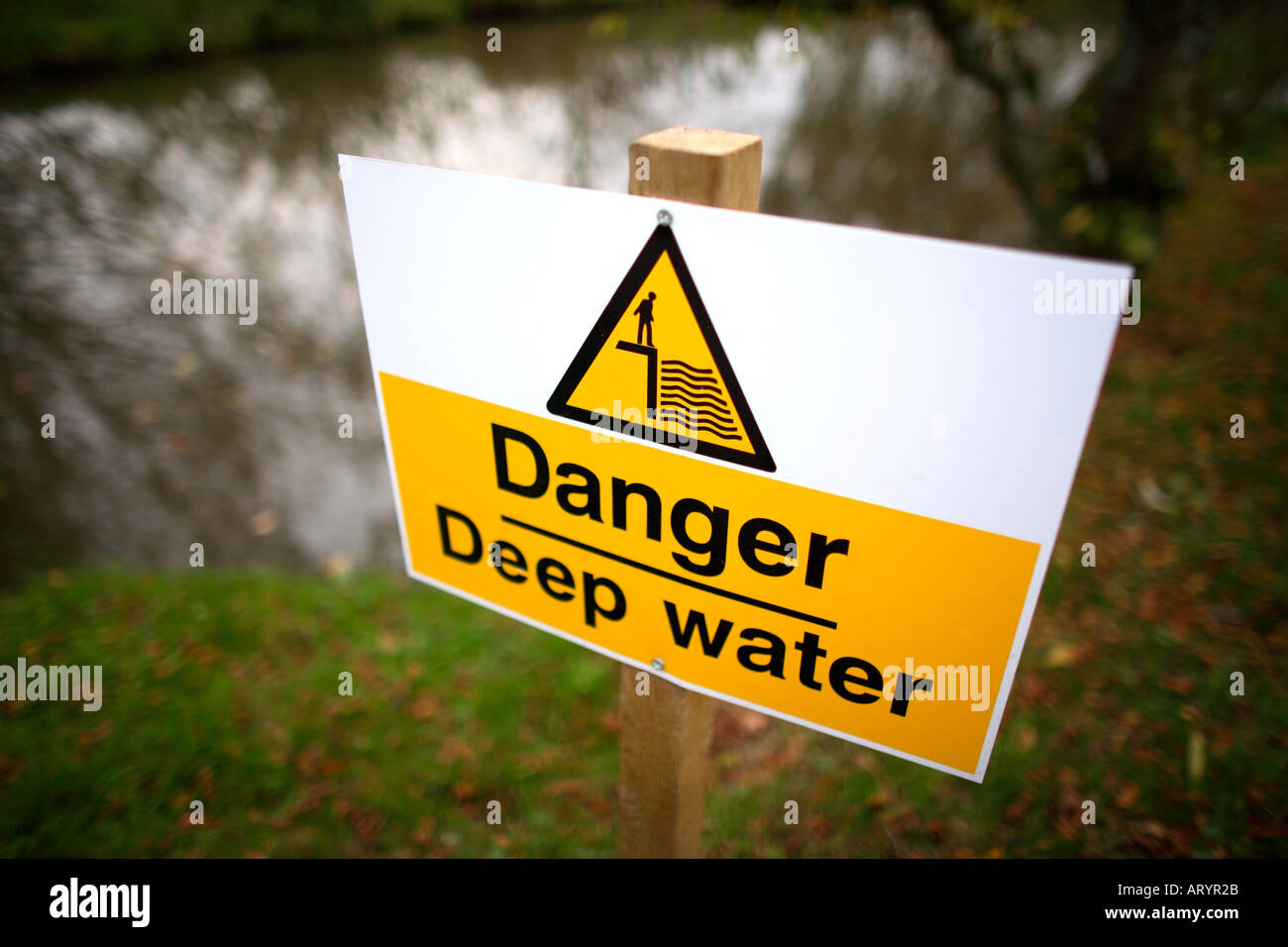 Danger deep water hazard signs near a river Stock Photo - Alamy