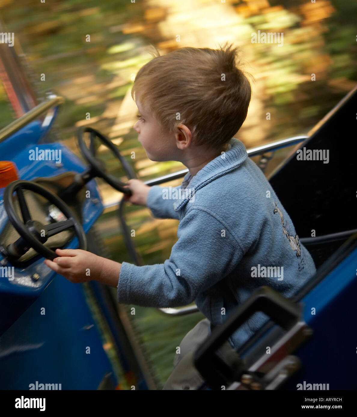 little boy driving with tractor Stock Photo - Alamy