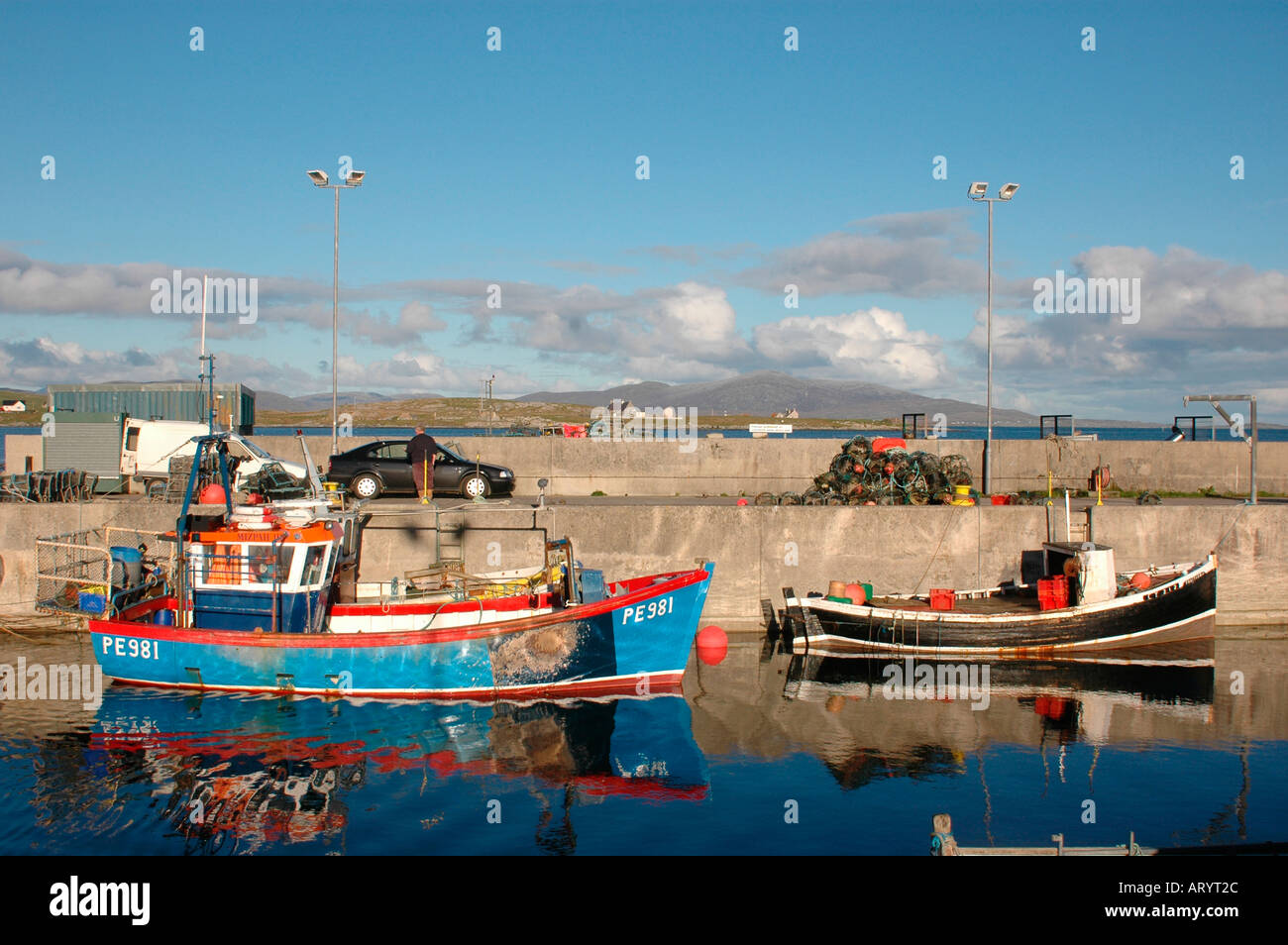 A blue and white fishing boat at the quayside Stock Photo - Alamy