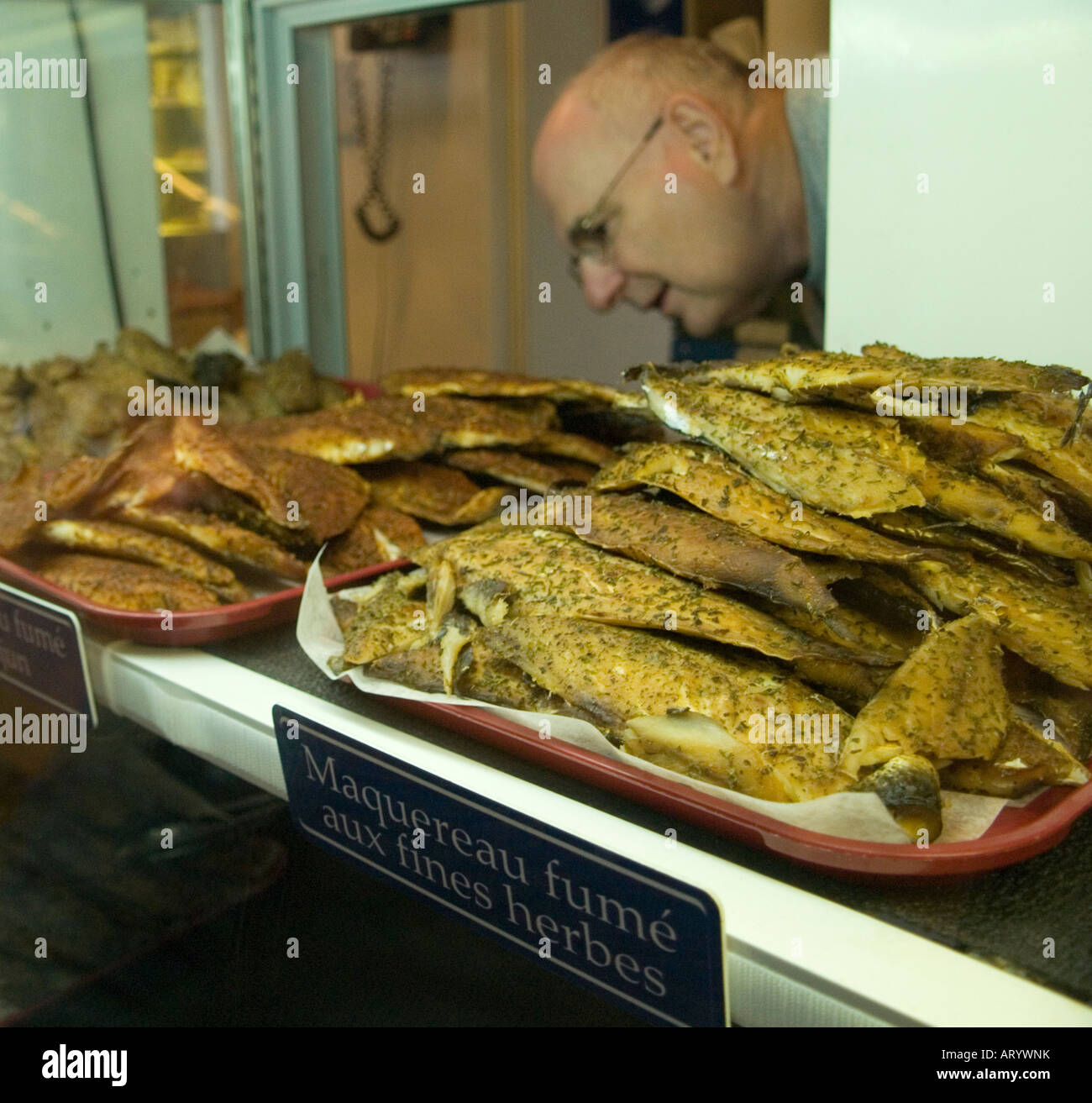 A man selling different varieties of Mackerel on a stall at the market ...