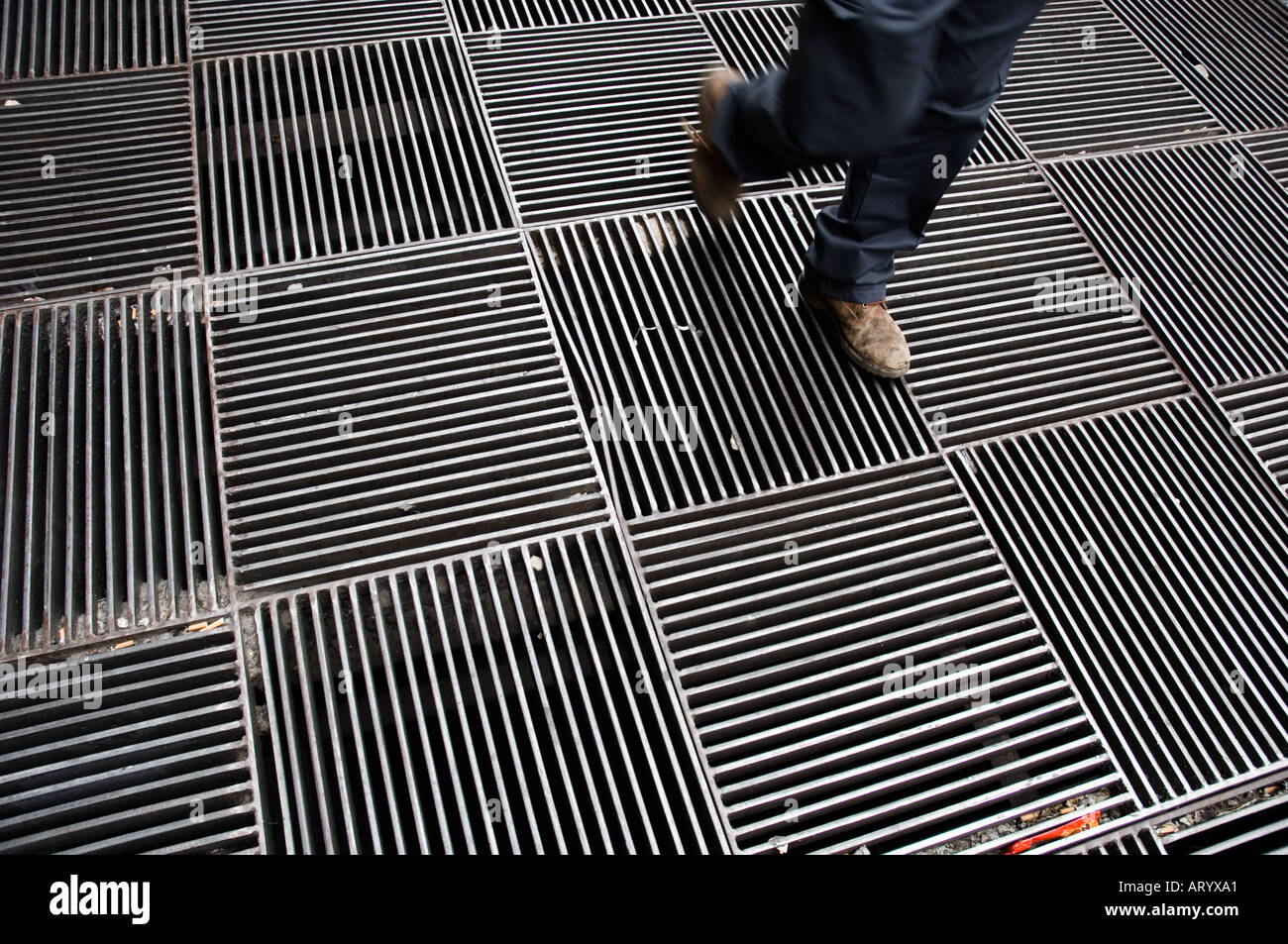 Pedestrian and a sidewalk of squares Stock Photo - Alamy