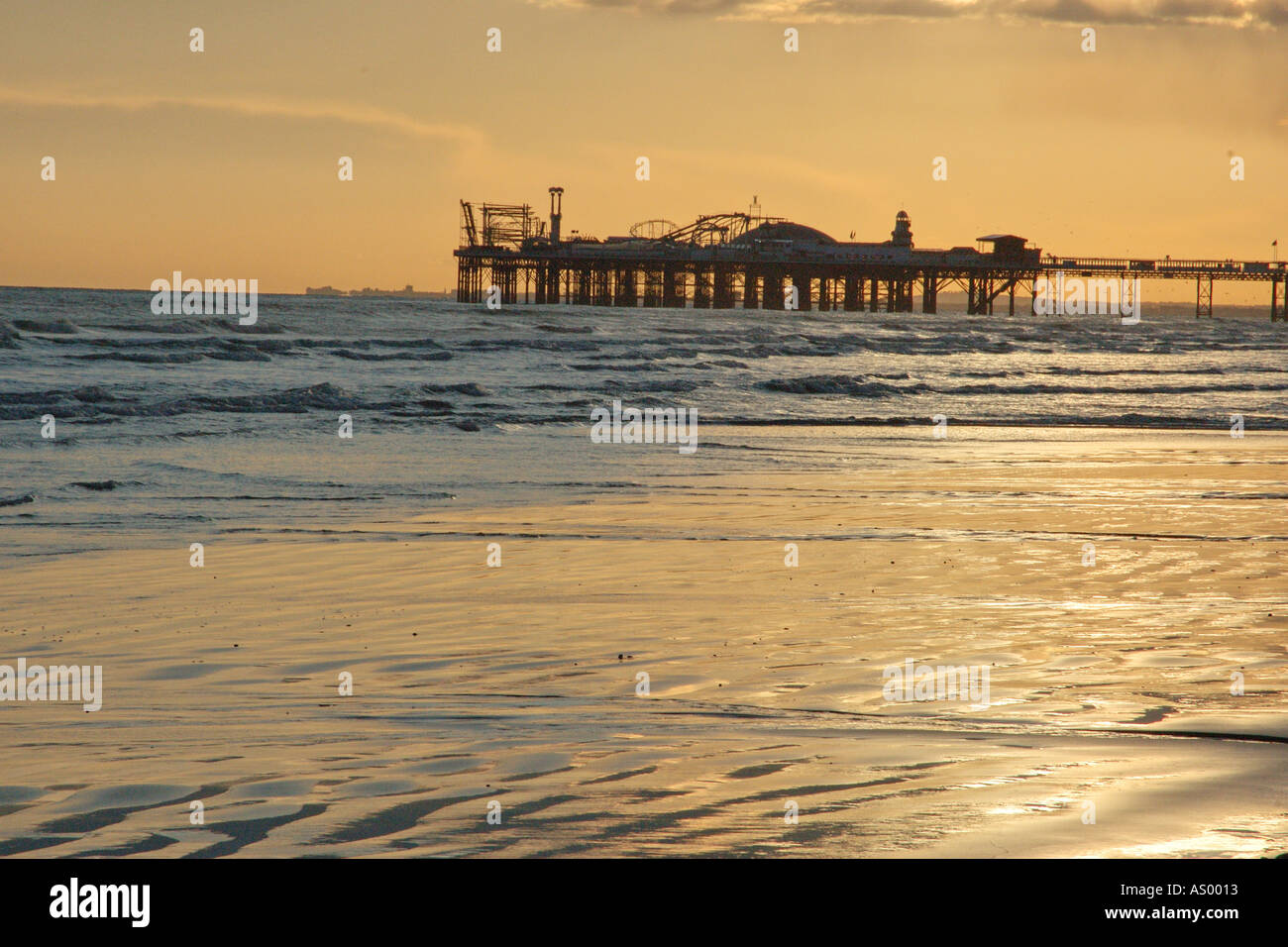 Wonderful sun set sun sinks into the water behind the ruined west pier ...