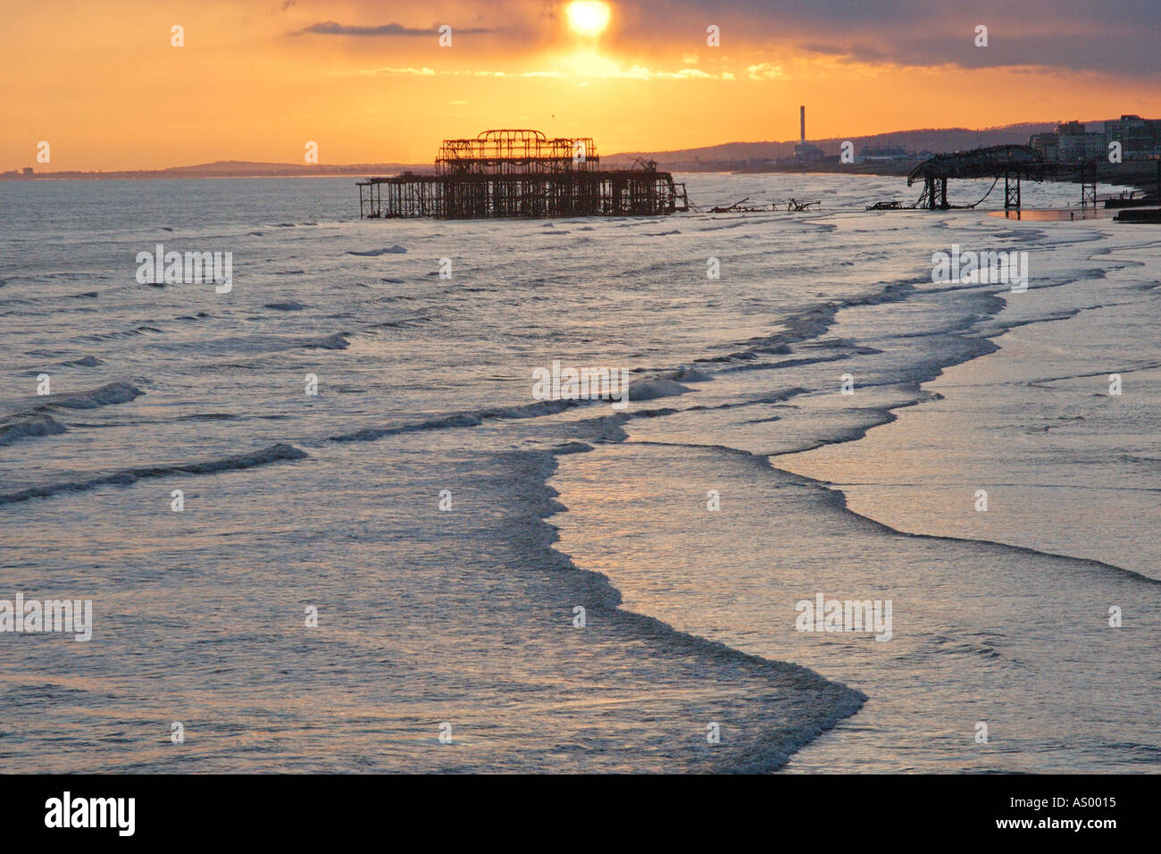 Wonderful sun set sun sinks into the water behind the ruined west pier ...