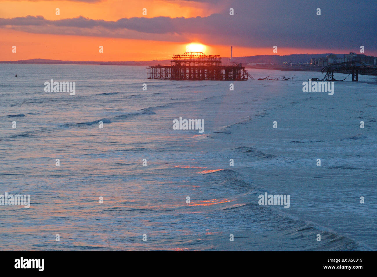 Wonderful sun set sun sinks into the water behind the ruined west pier ...
