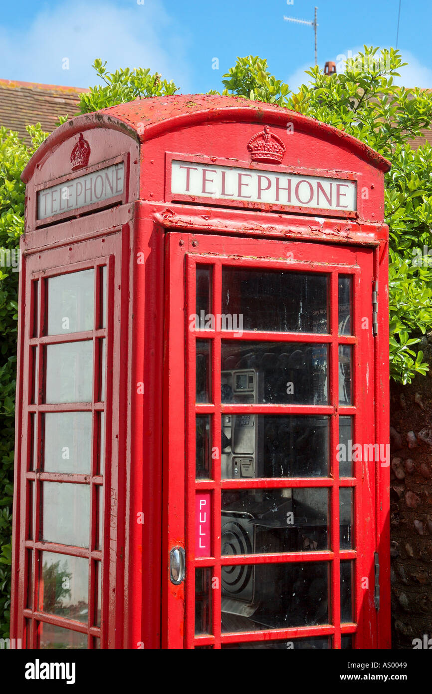 Bright red British Telecom phone box in a typical country village Bold ...