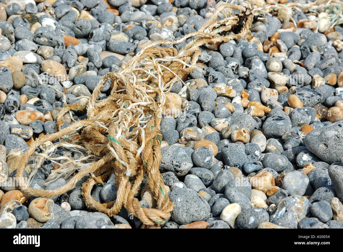 Frayed string on a pebbly beach Stock Photo - Alamy