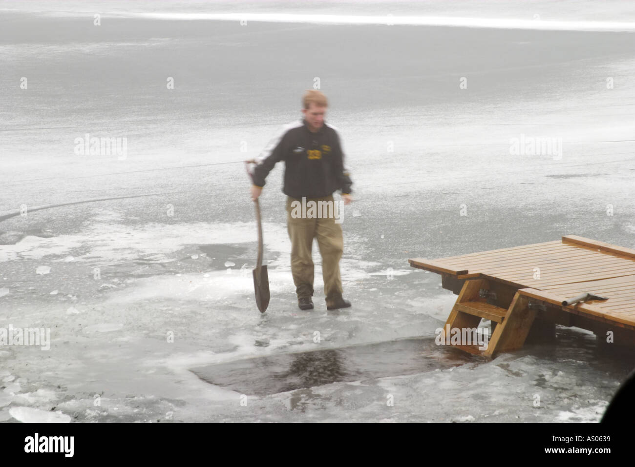 digging a hole in an iced lake Göteborg Sweden Stock Photo - Alamy
