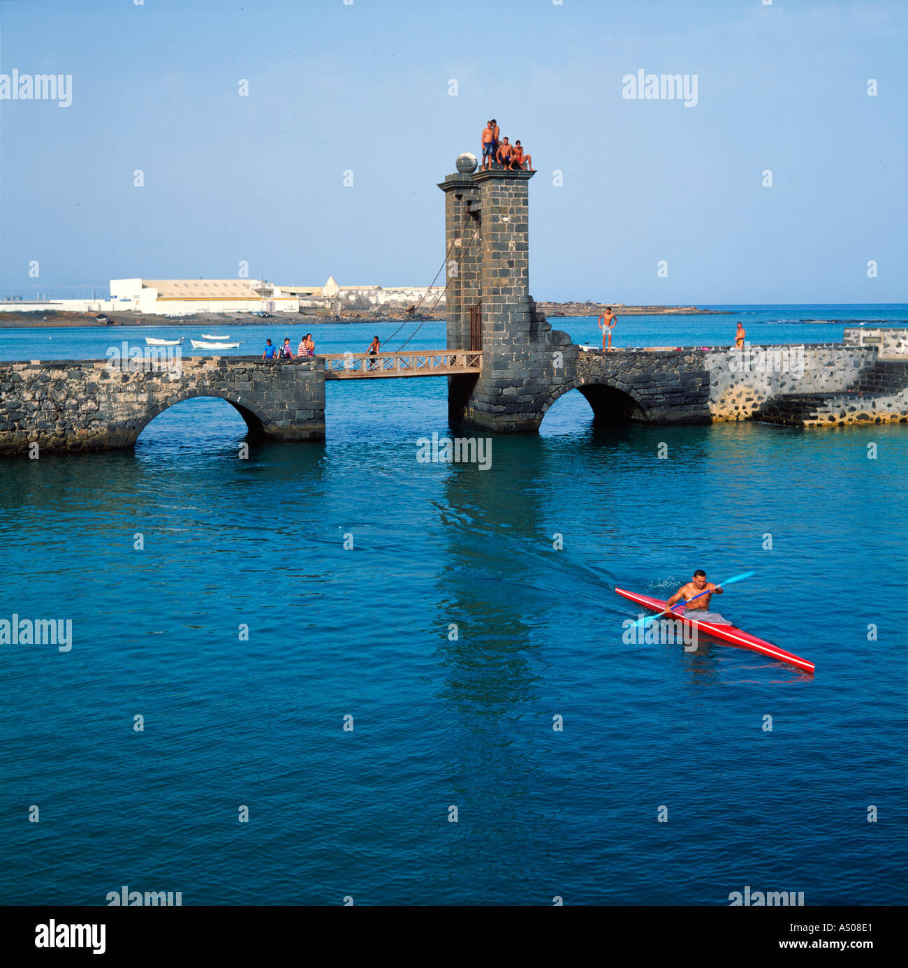 Canoe through stone bridge Stock Photo - Alamy