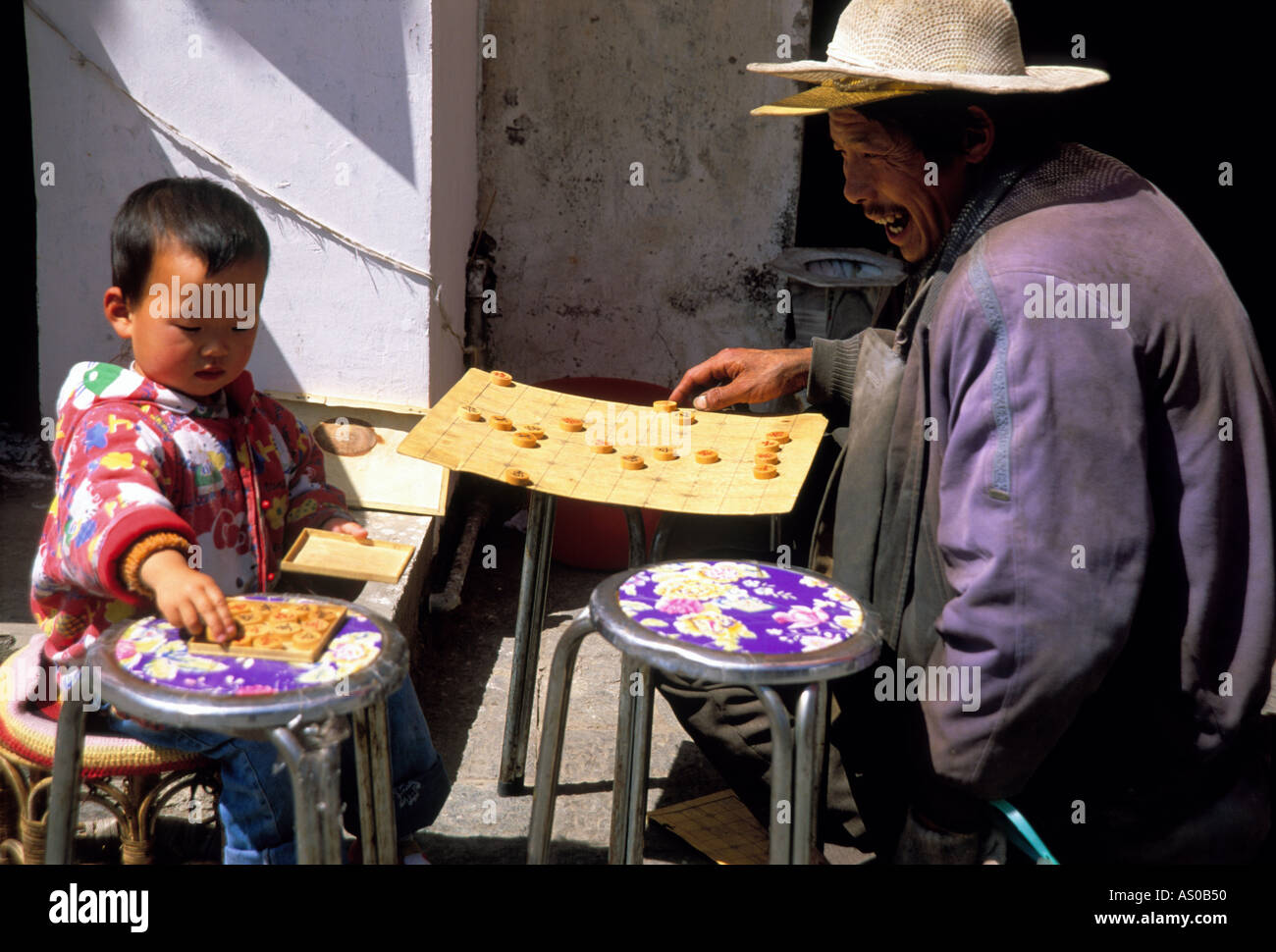 Playing board game Dali Yunnan Province China Stock Photo - Alamy