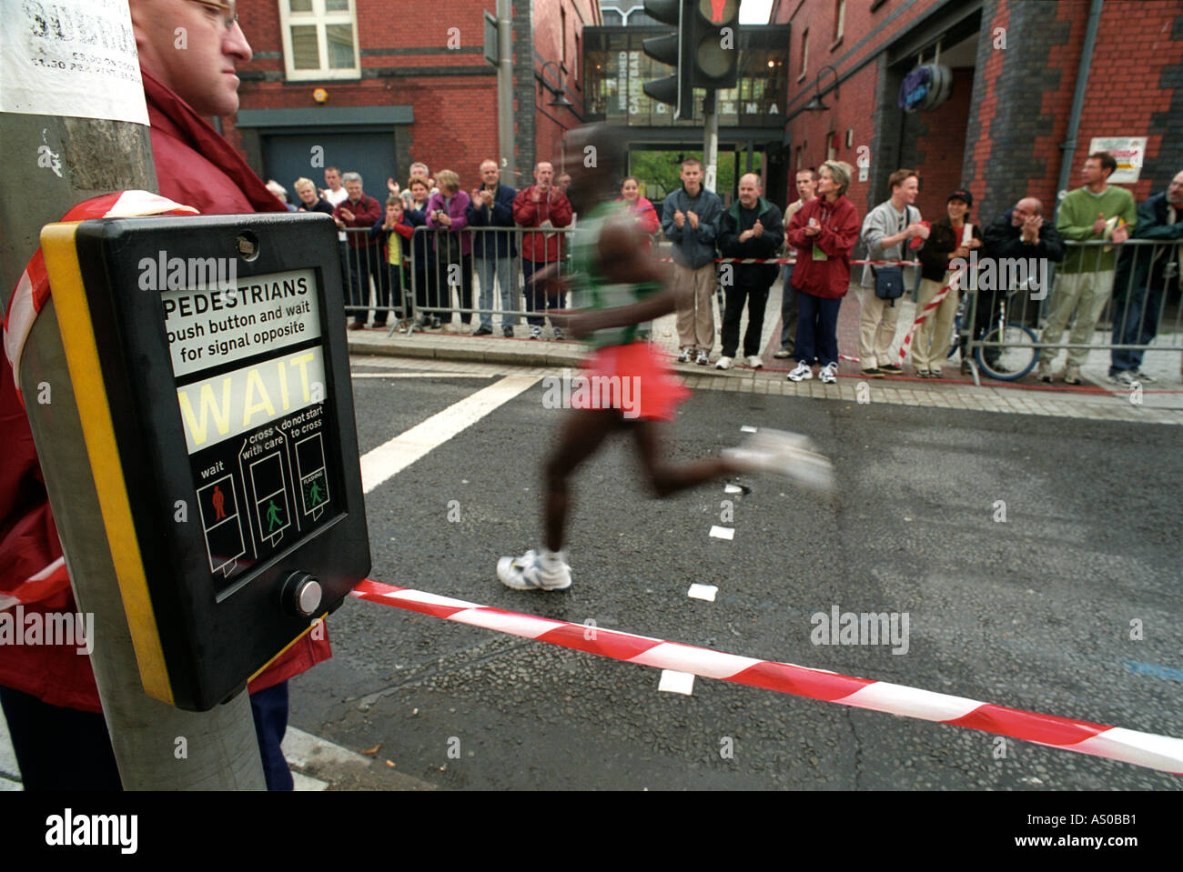 A marathon runner beside a walk sign Stock Photo - Alamy