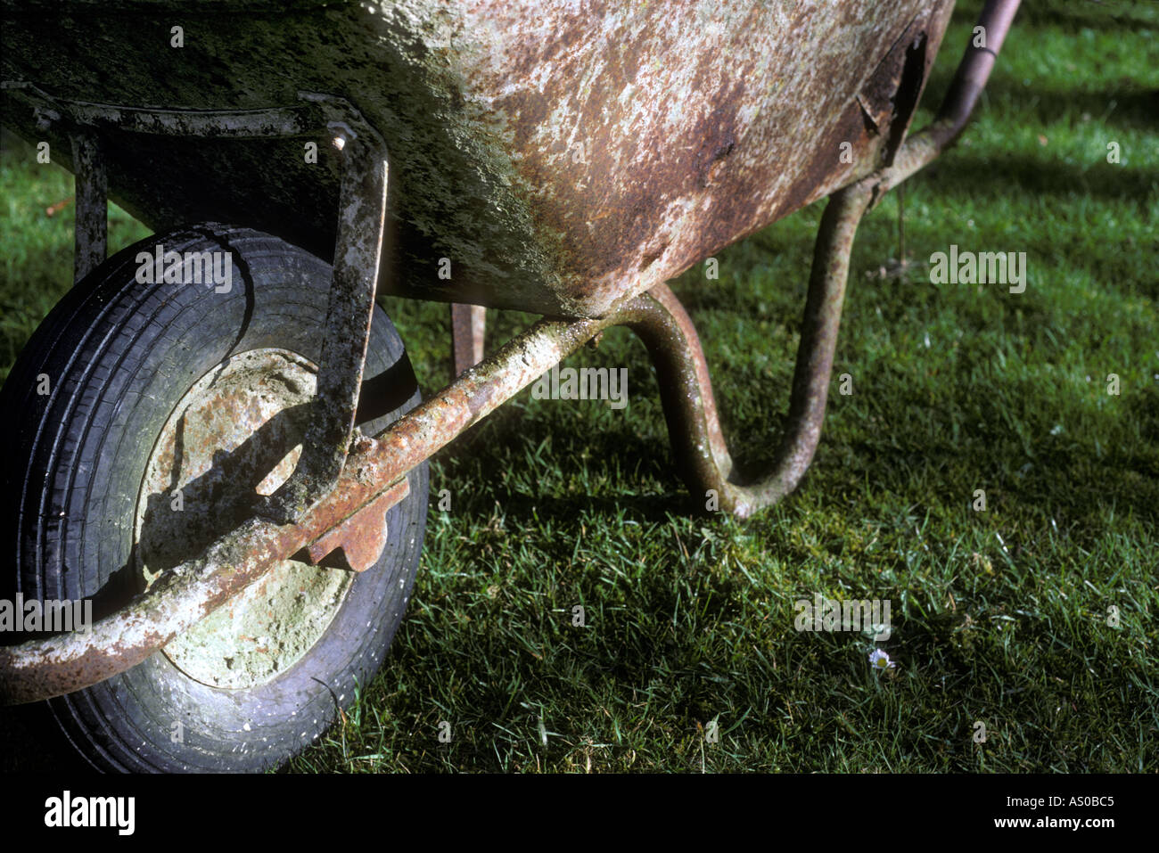 An old rusty wheelbarrow in a garden Stock Photo - Alamy