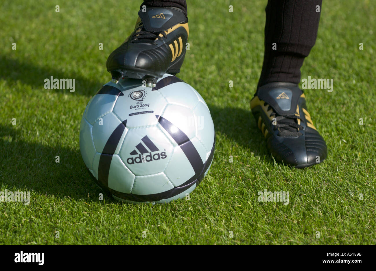 soccer player resting his foot on the Ball of the Euro 2004 Stock Photo ...