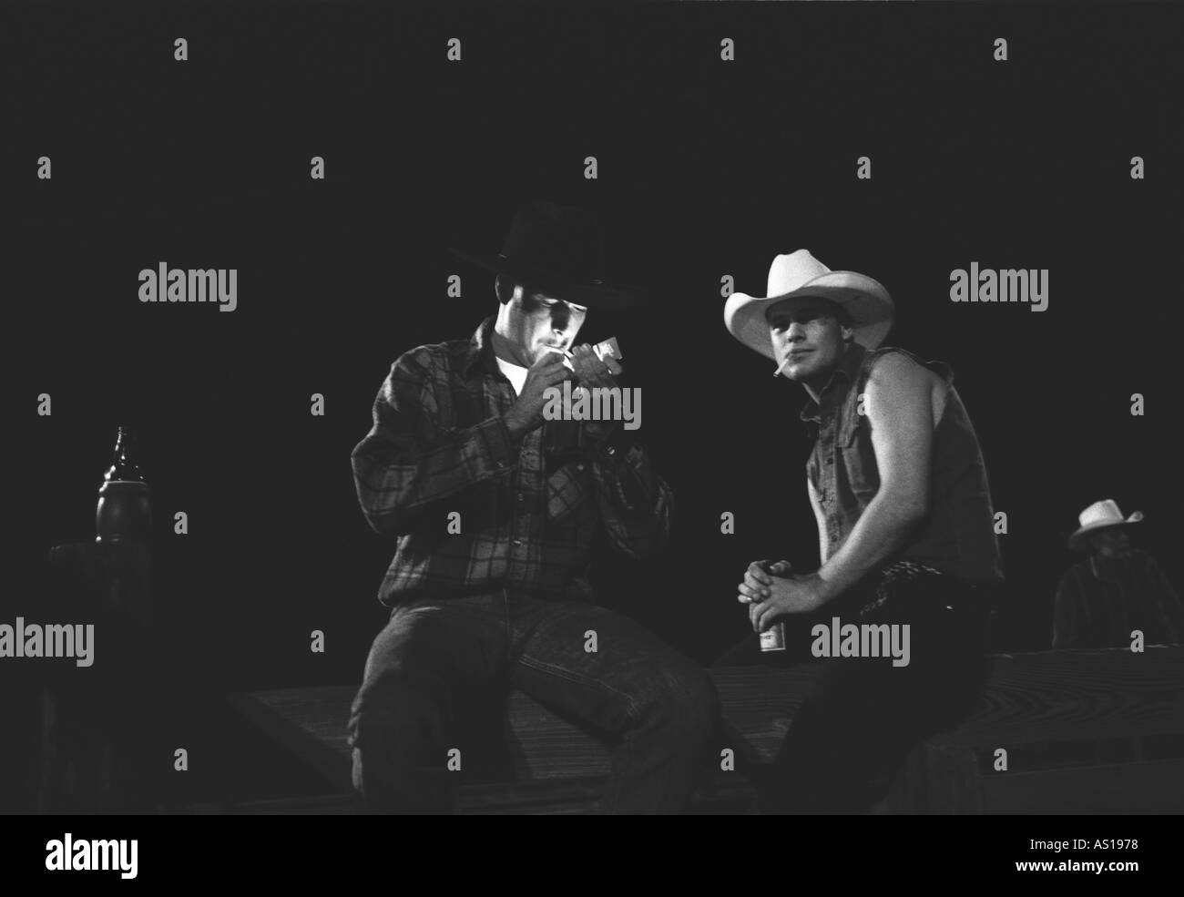 Cowboys sitting fence Black and White Stock Photos & Images - Alamy