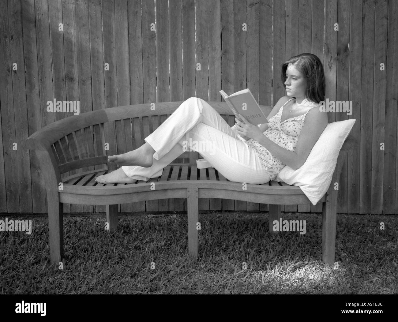 Women lying on bench Stock Photo - Alamy
