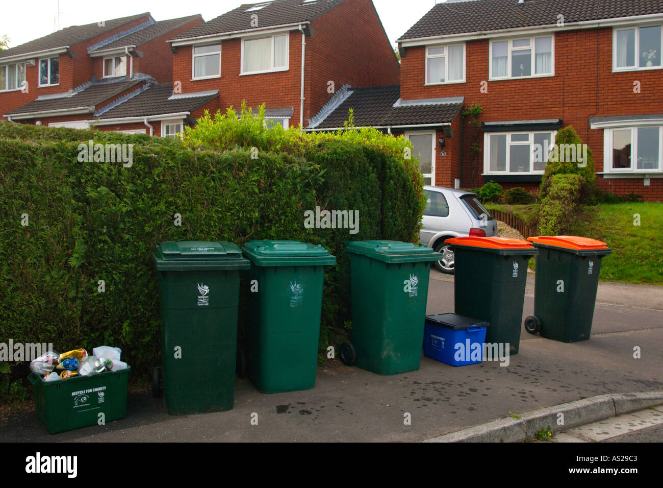 Boxes filled with material for recycling and wheelie bins full of ...