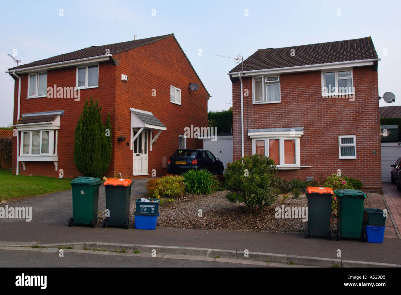 Boxes filled with material for recycling and wheelie bins full of ...